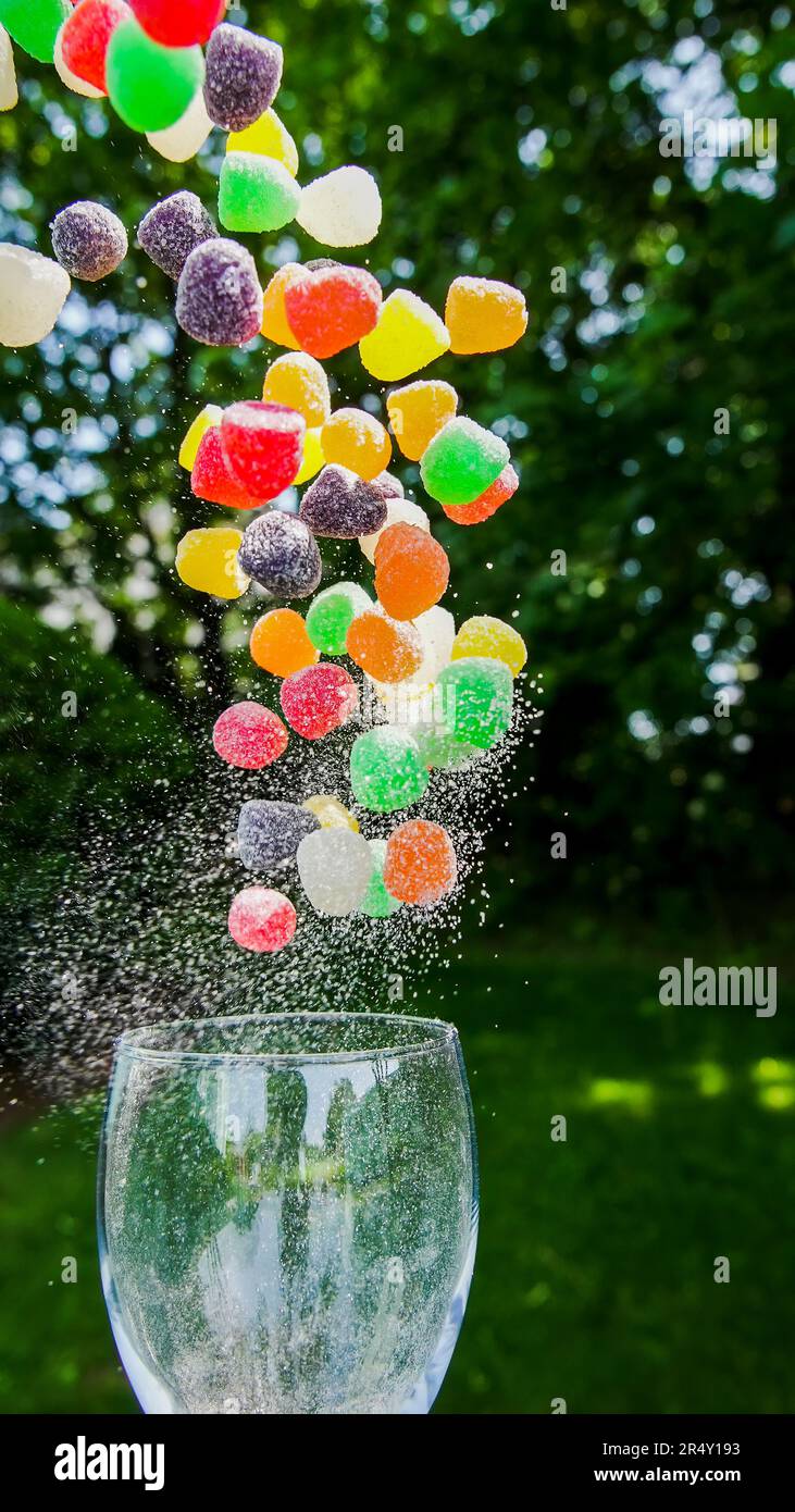 Colorful candy flying out from inside glass outdoor Stock Photo - Alamy