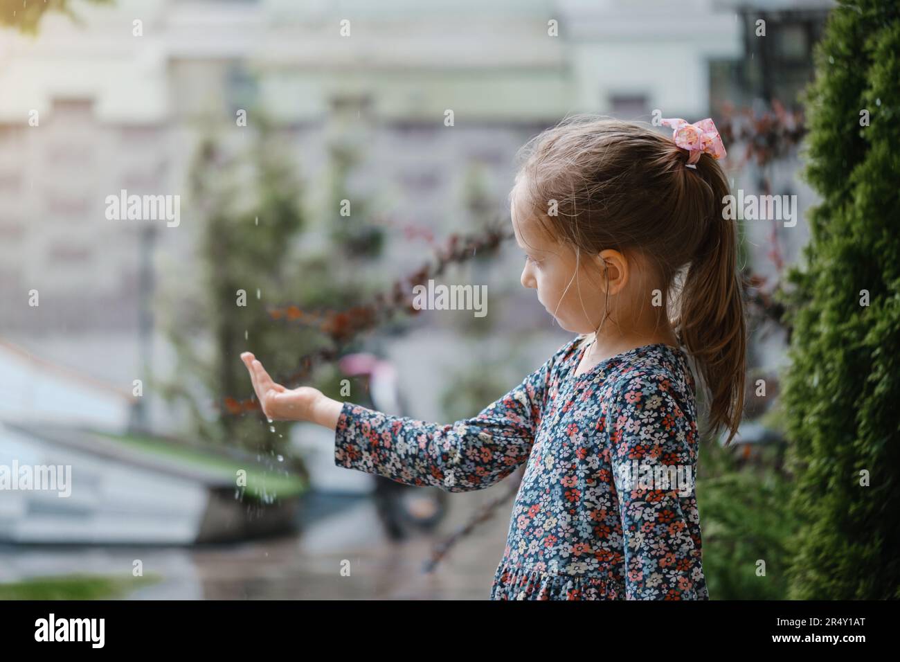 kids hands catching raindrops, weather concept. rain falling in girls ...
