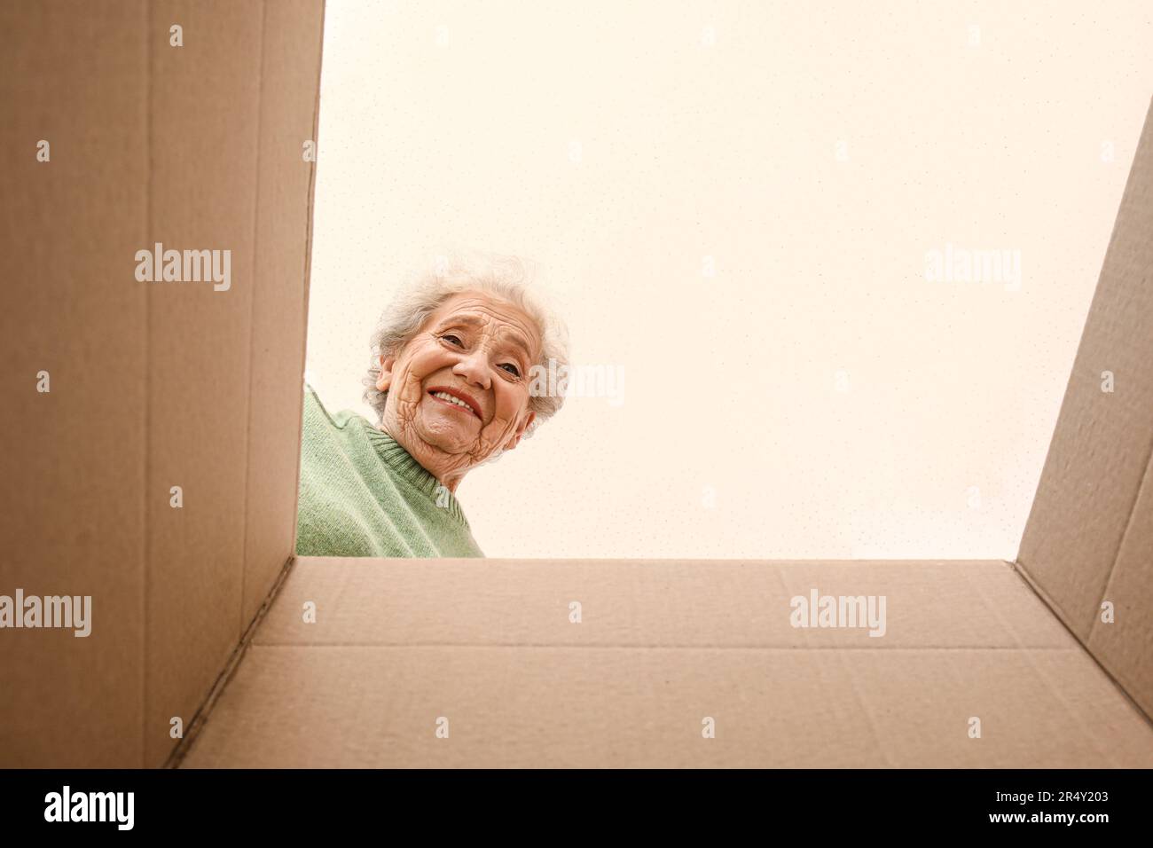 Senior woman opening parcel box hi-res stock photography and images - Alamy