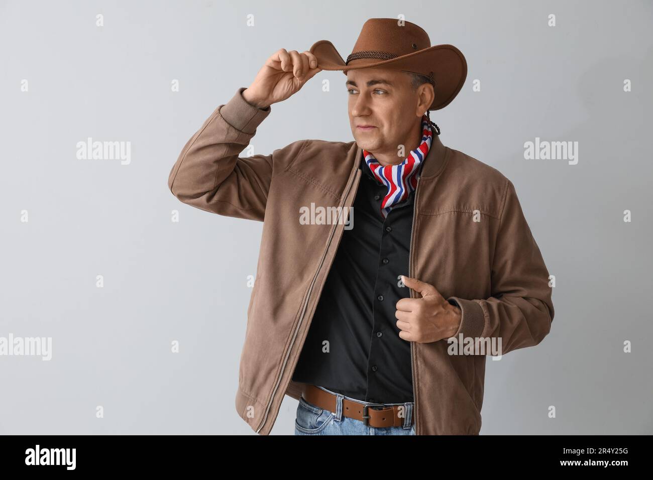 Mature cowboy on light background Stock Photo - Alamy