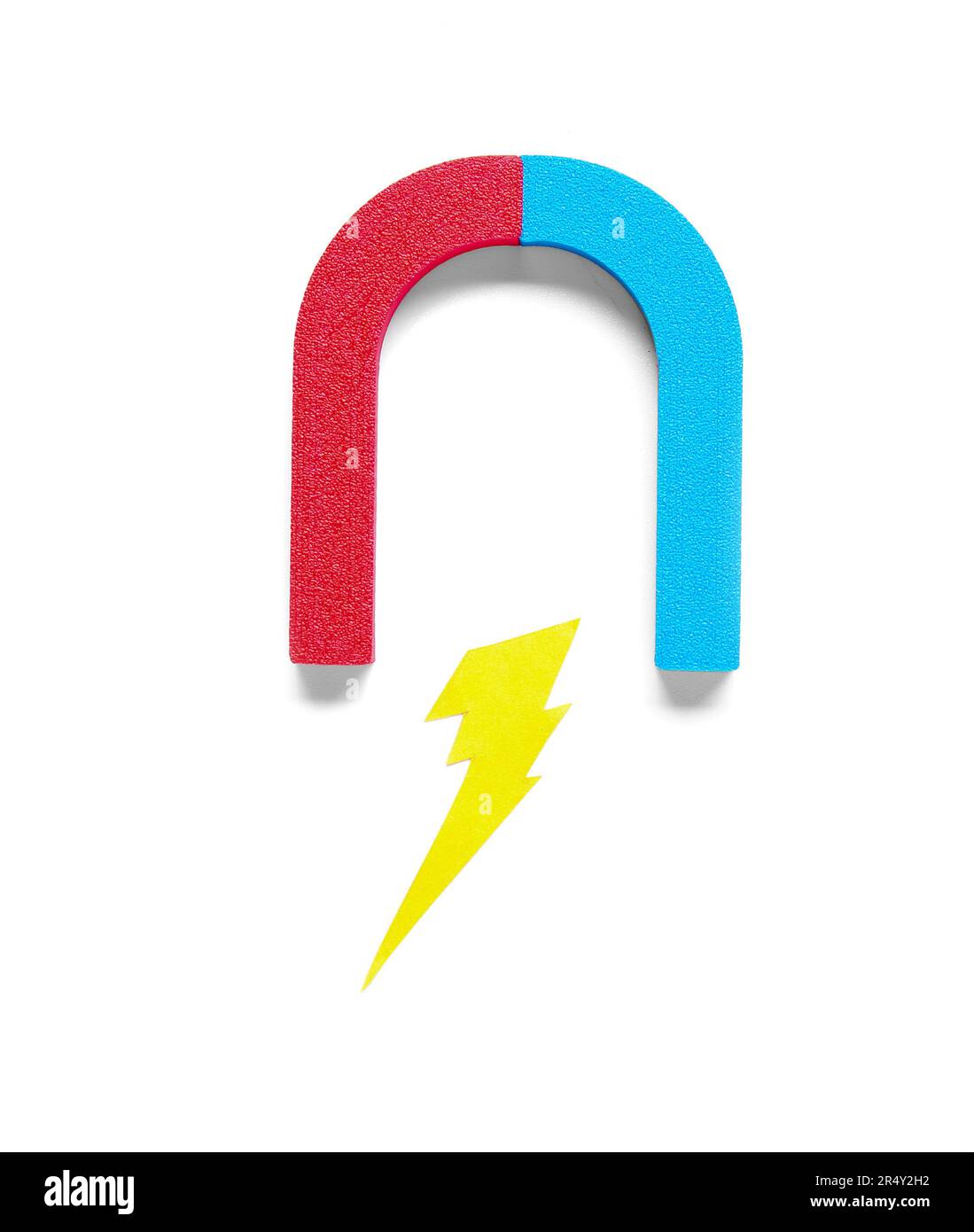 Paper lightning with horseshoe shaped magnet on white background Stock ...