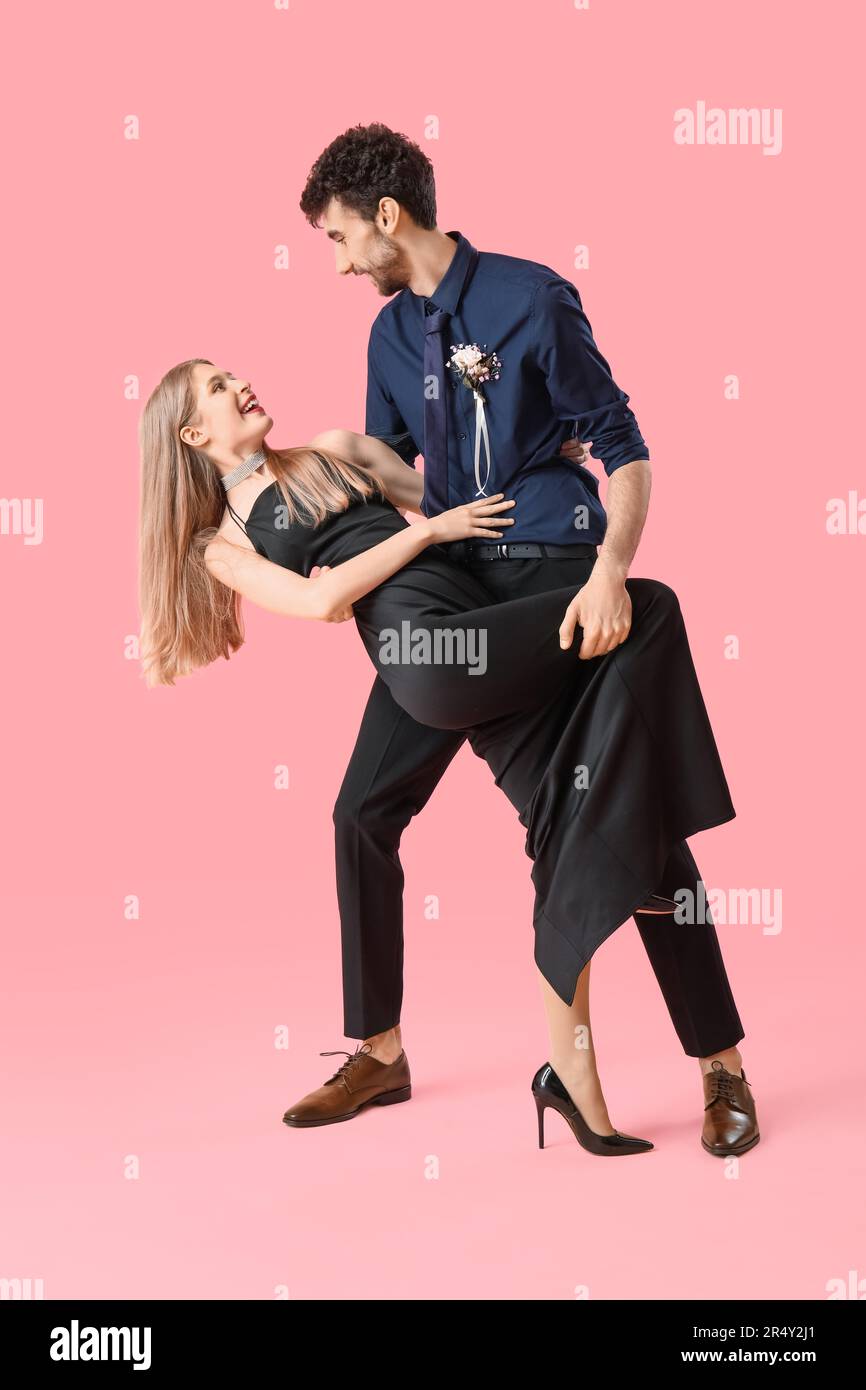 Beautiful prom couple dancing on pink background Stock Photo - Alamy