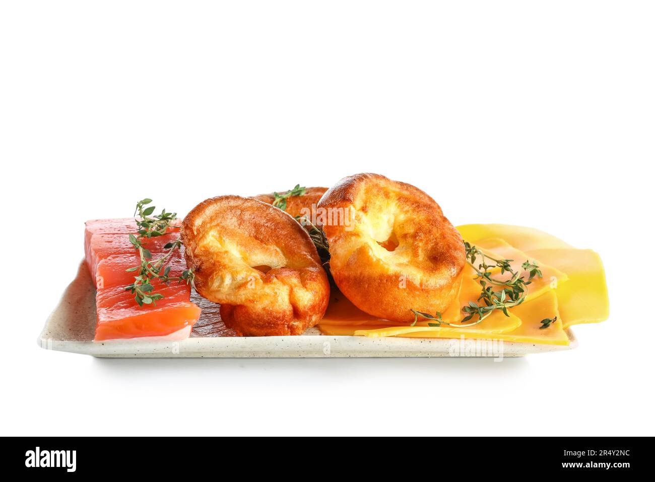 Plate with tasty Yorkshire pudding, fish and cheese isolated on white ...