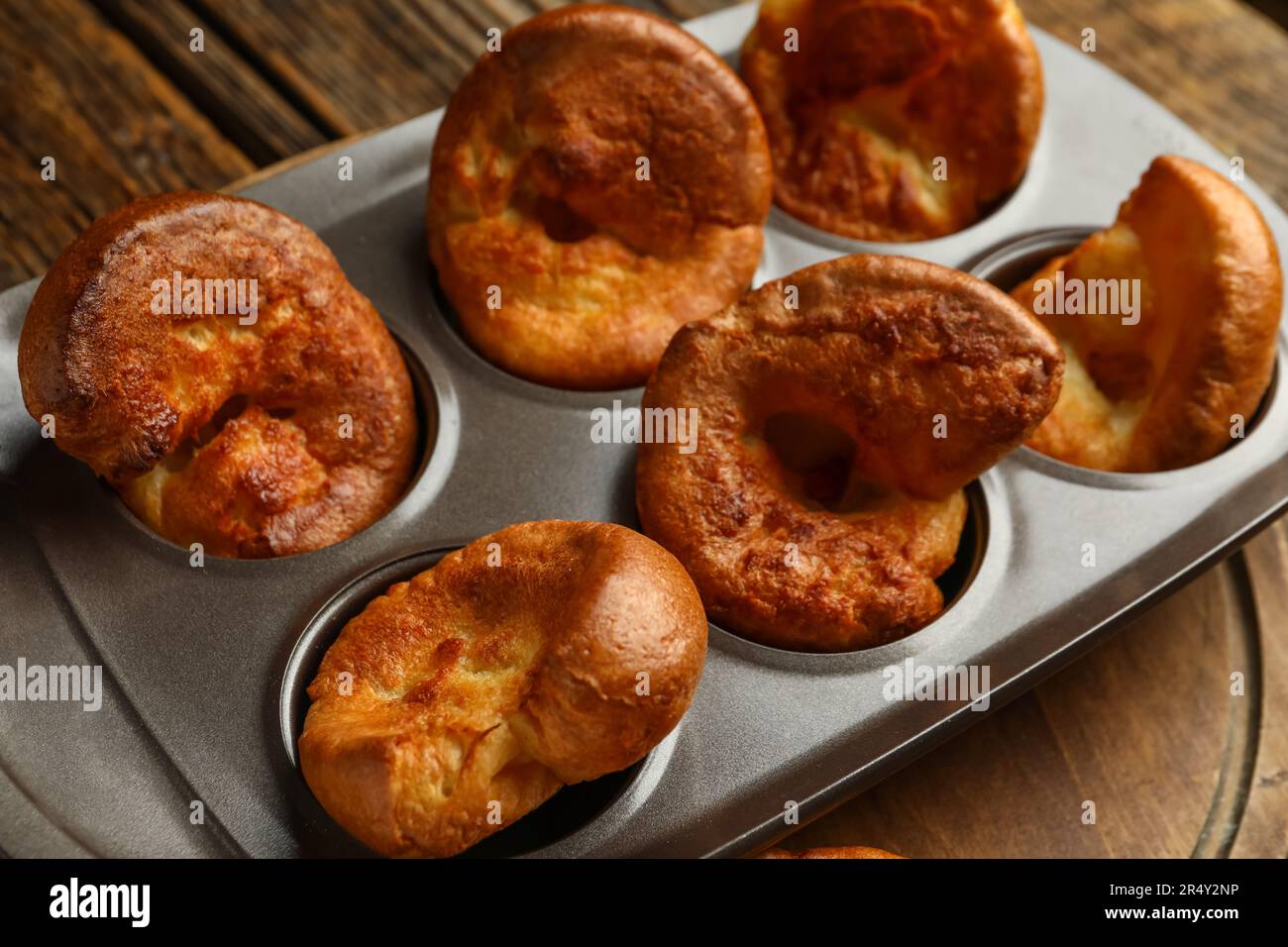 Baking tin with tasty Yorkshire pudding on wooden background Stock ...