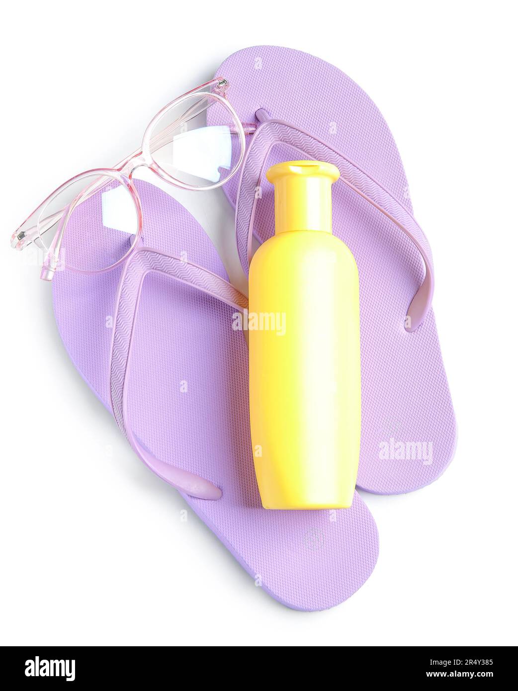 Bottle of sunscreen cream with sunglasses and flip flops isolated on ...