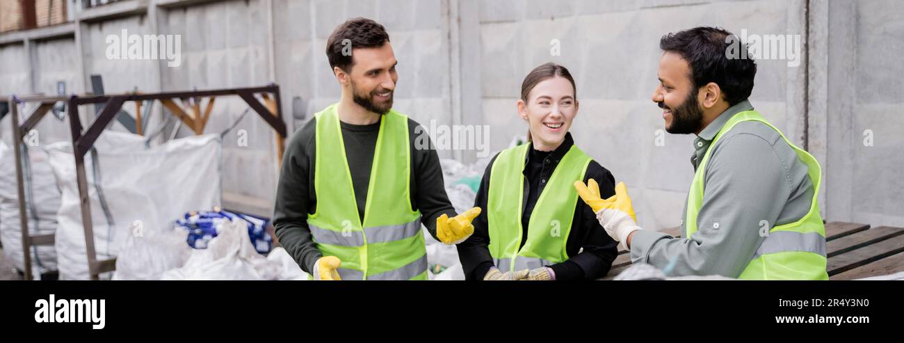 Cheerful multiethnic sorters in high visibility vests and gloves ...