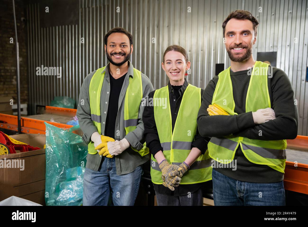 Positive interracial workers in high visibility vests and gloves ...