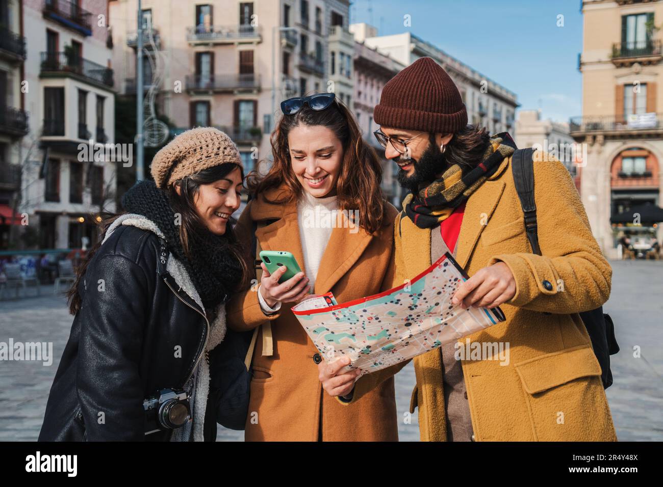 Group of tourist people sightseeing and searching a location on a map ...