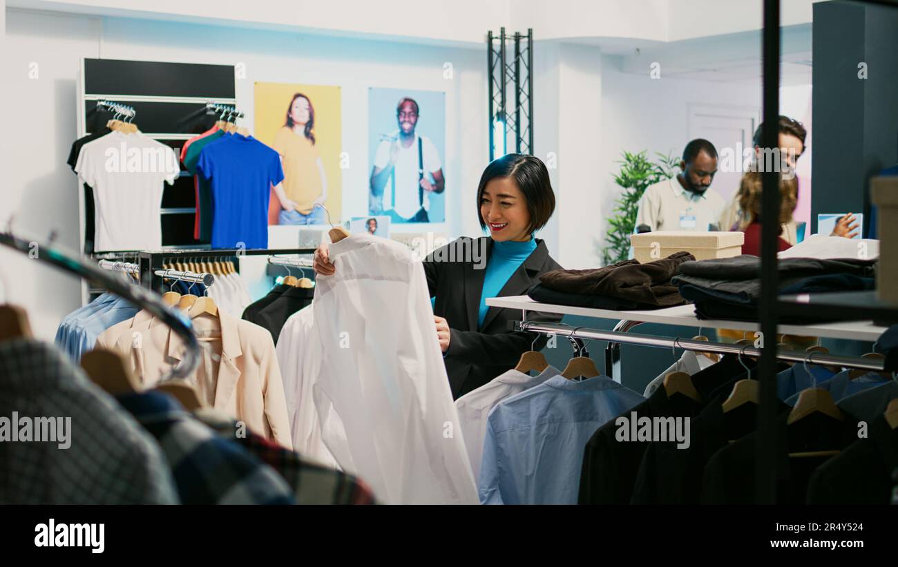 Asian customer examining formal clothes hi-res stock photography and ...