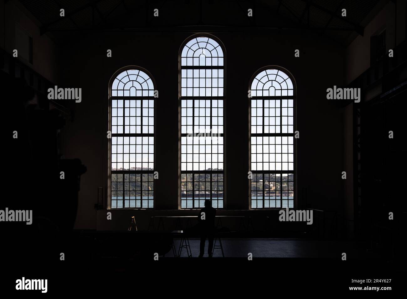 Silhouette of Industrial Interior with Large Windows Facing the River ...