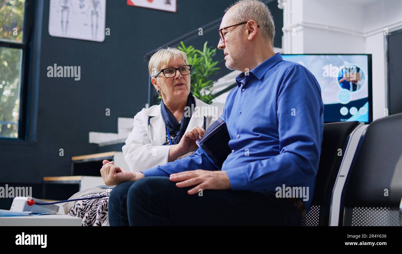 Elderly physician using tonometer hi-res stock photography and images ...