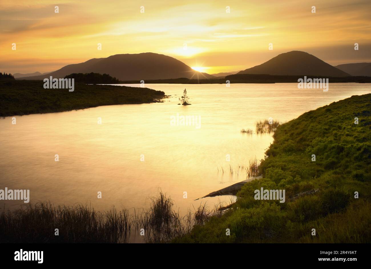 Beautiful golden hour sunset landscape scenery with lake and mountains ...