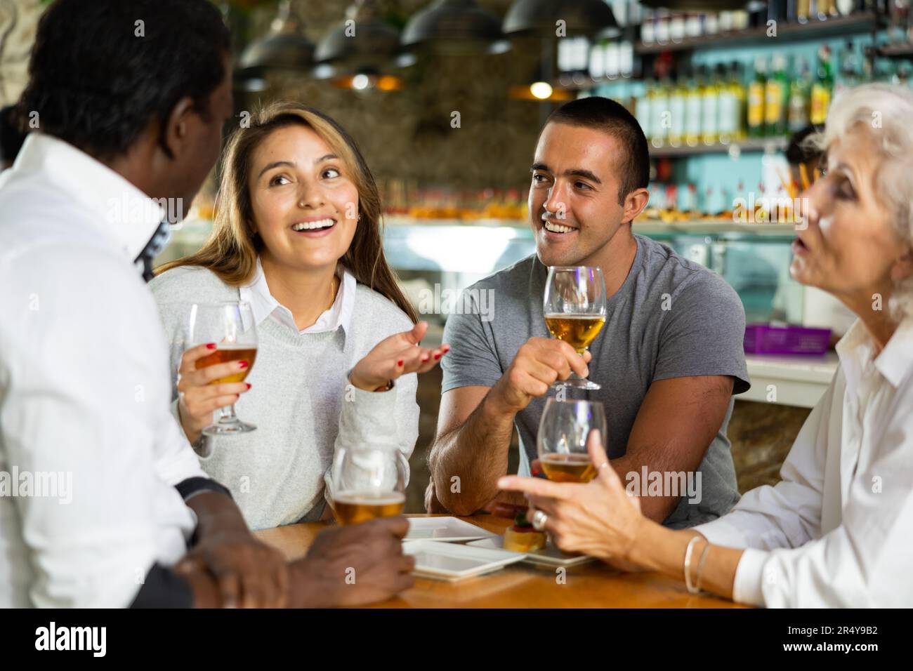 People talking and toasting in pub with the beers Stock Photo - Alamy