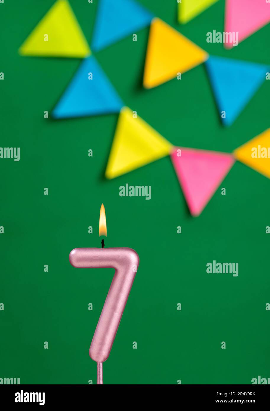 Number 7 candle - Birthday celebration on green background Stock Photo ...
