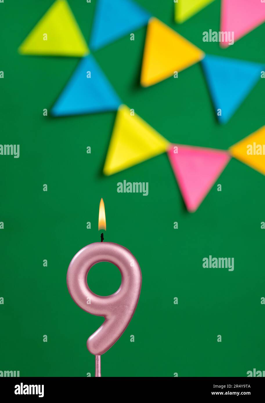 Number 9 candle - Birthday celebration on green background Stock Photo ...