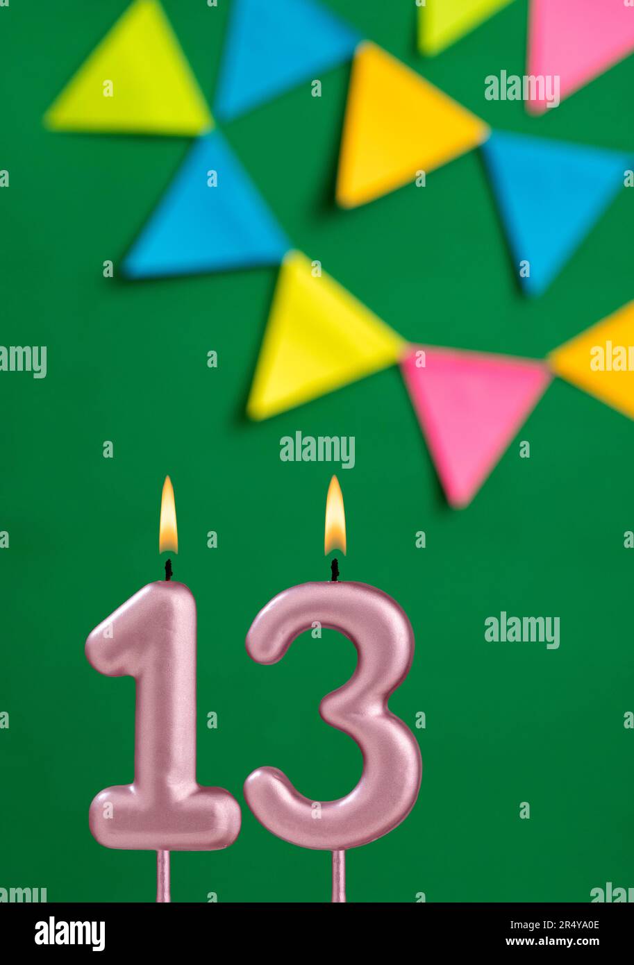 Number 13 candle - Birthday celebration on green background Stock Photo ...