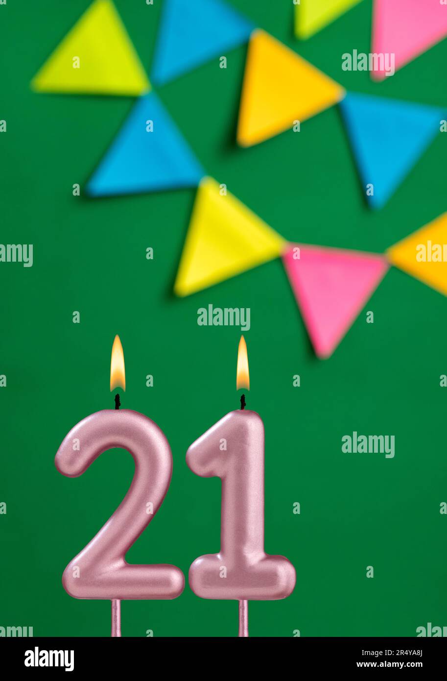 Number 21 candle - Birthday celebration on green background Stock Photo ...