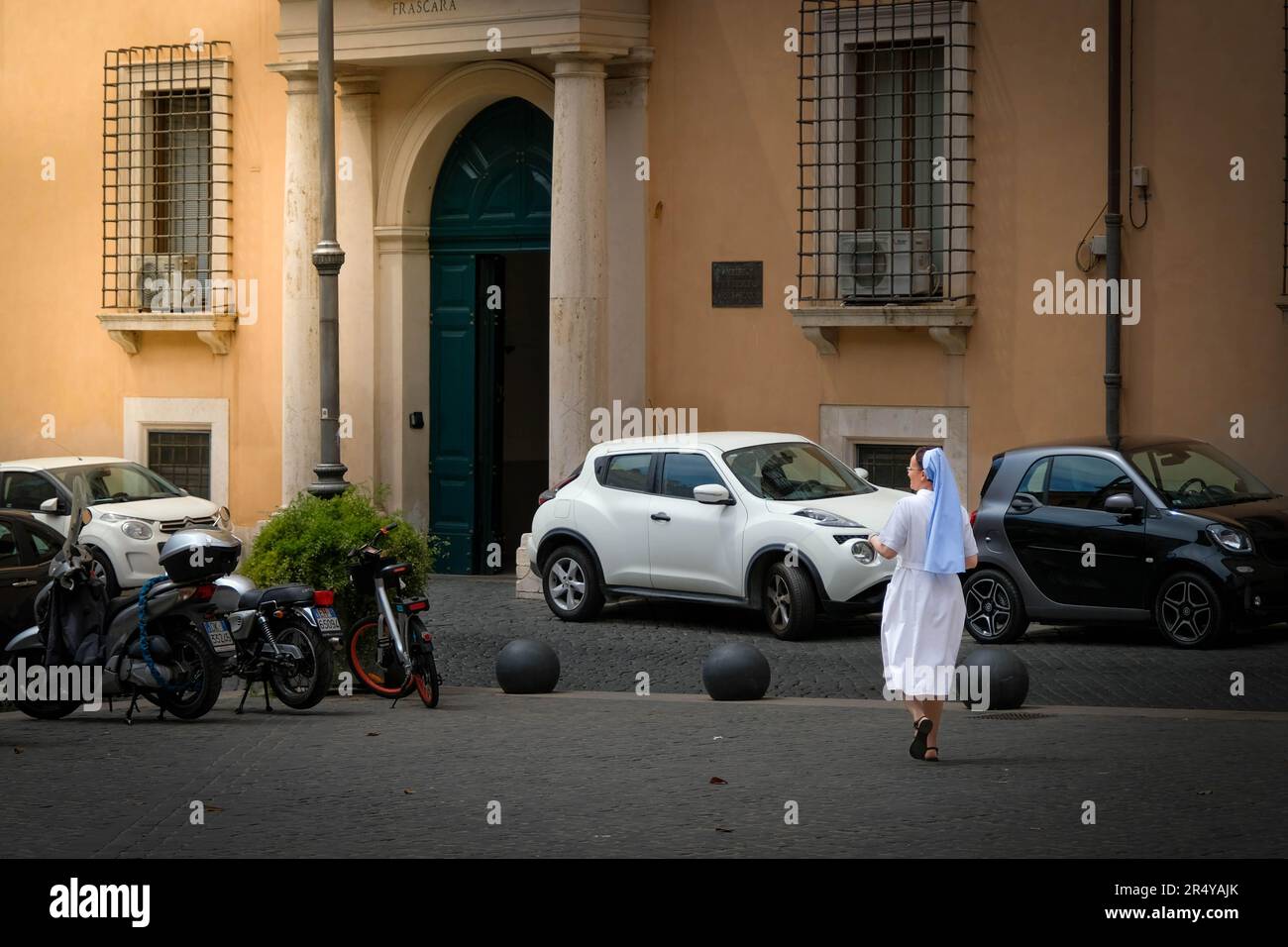 Rome, Italy - June 6, 2022: Catholic Nun about to cross a street in ...