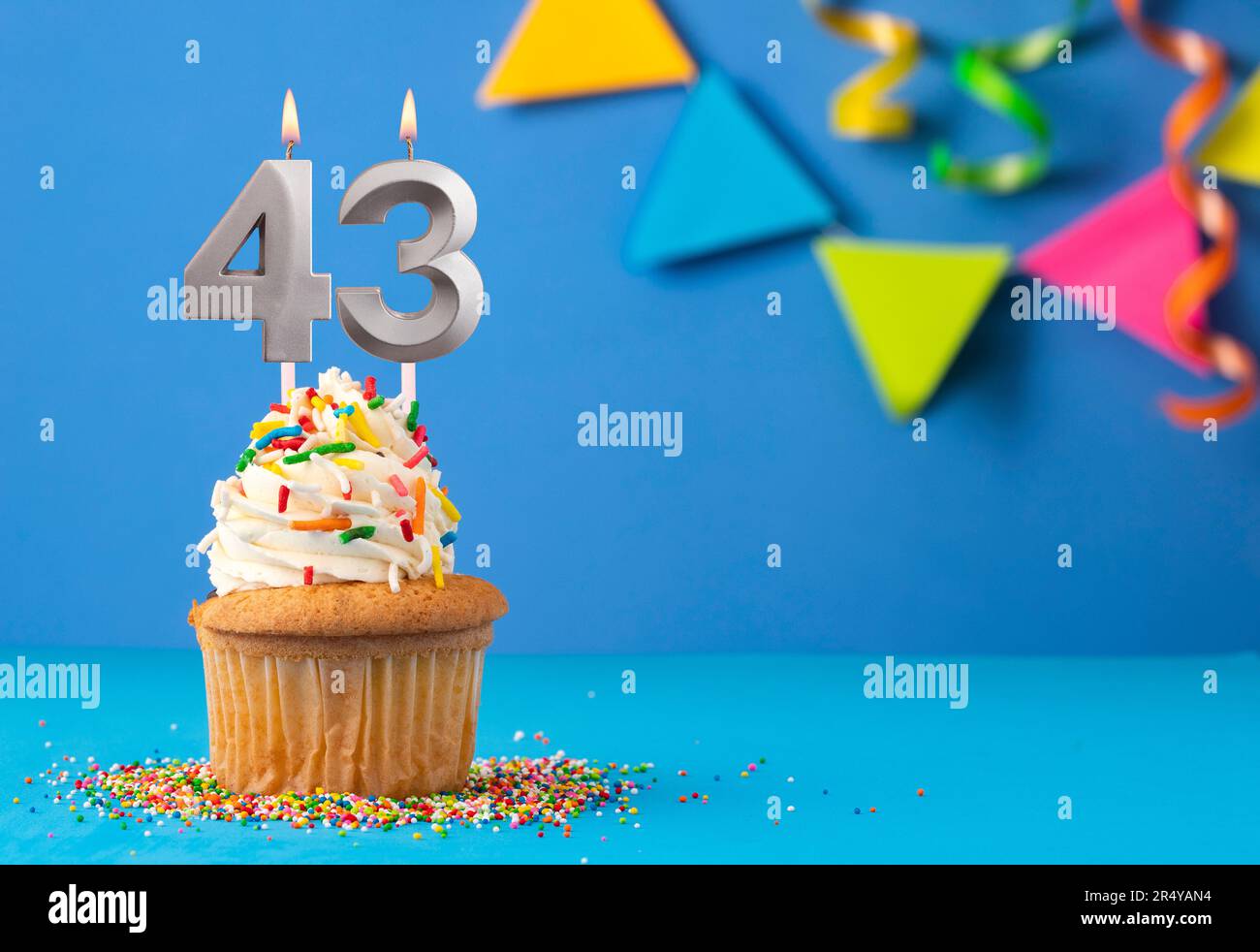 Birthday cake with candle number 43 - Blue background Stock Photo - Alamy