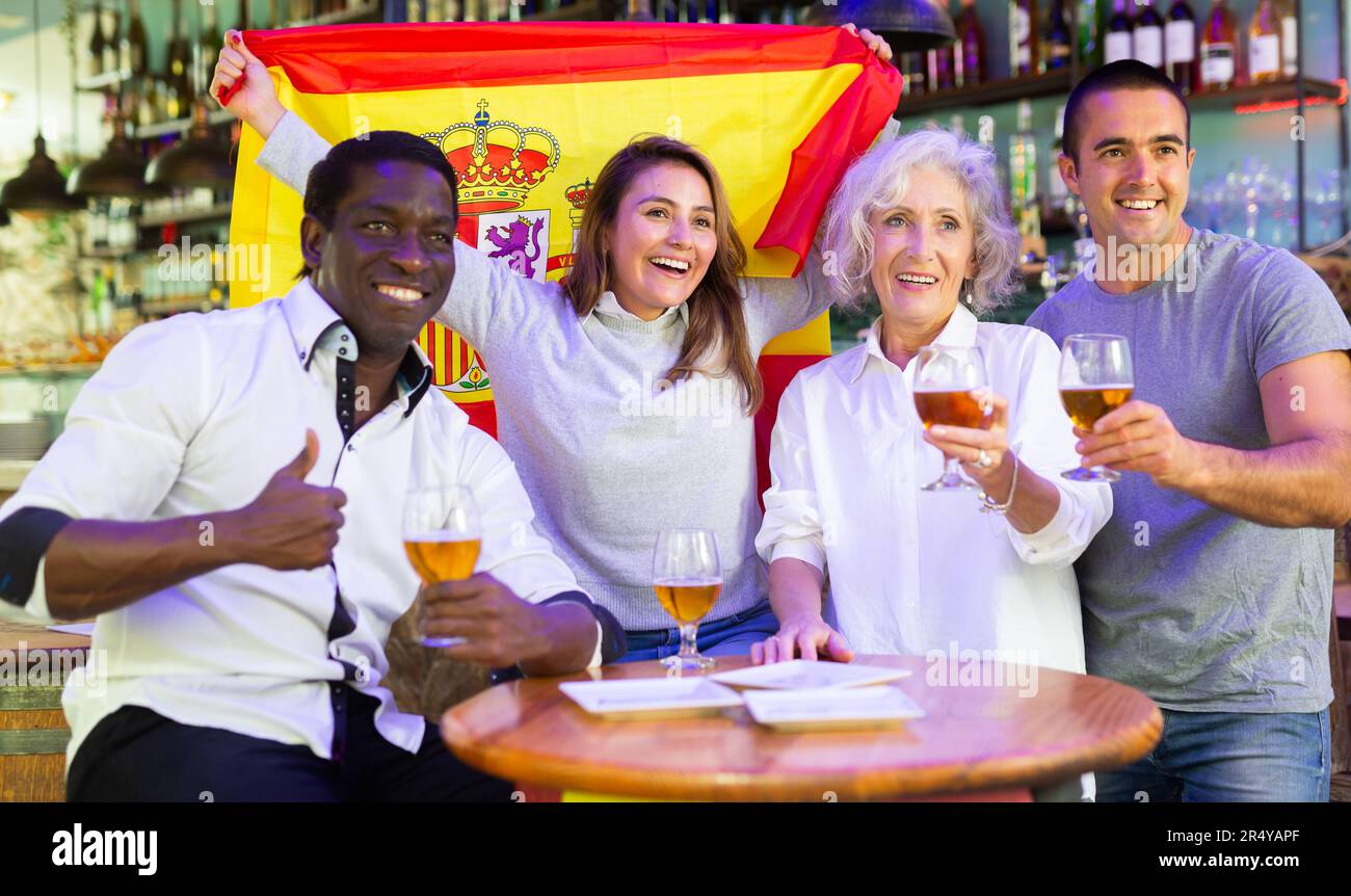 Diverse group celebrating with Spanish flag Stock Photo - Alamy