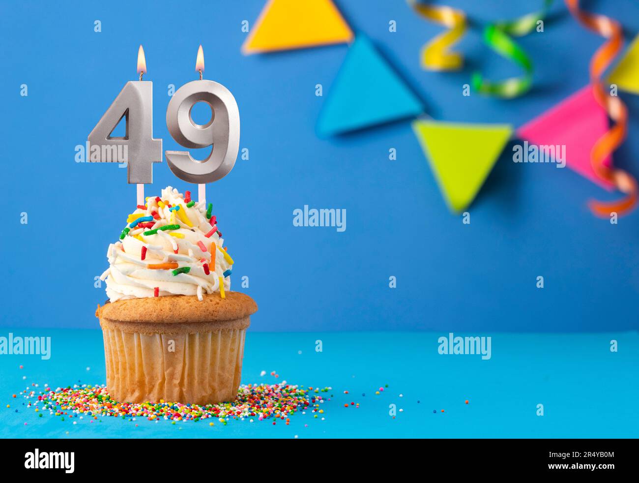Birthday cake with candle number 49 - Blue background Stock Photo - Alamy