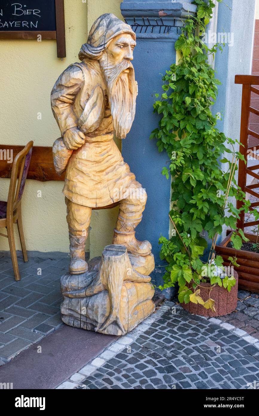 Wood carved statue in front of a restaurant on Marktstrasse in Altstadt ...