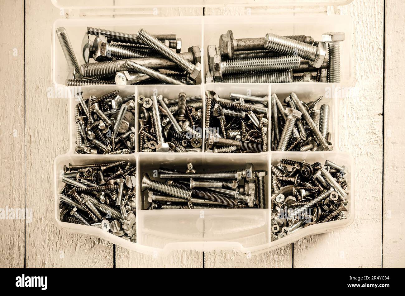 Silver and gold metal screws. Tool box with screws and bolts on a ...