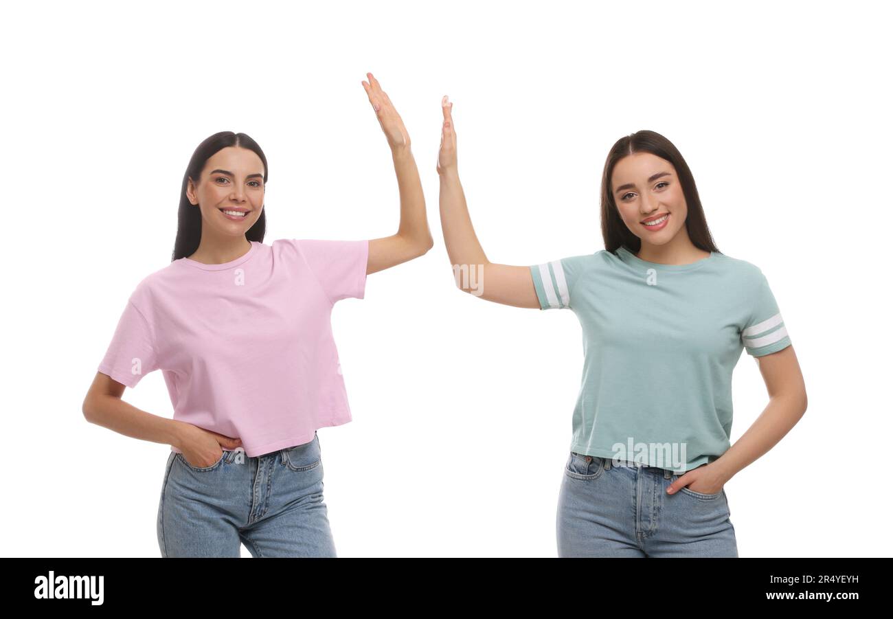 Women giving high five on white background Stock Photo - Alamy