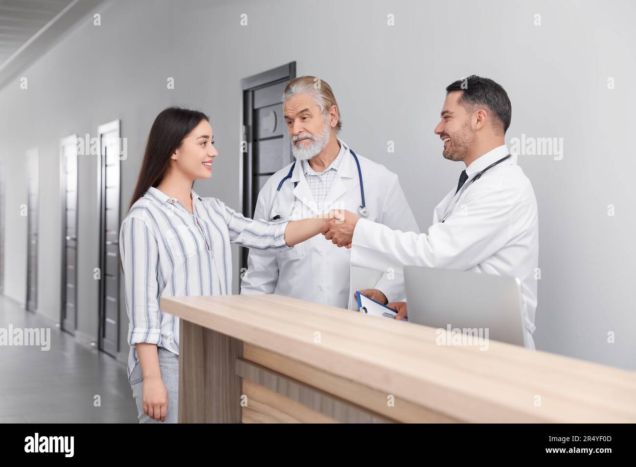 Doctor shaking hands with patient in hospital Stock Photo - Alamy