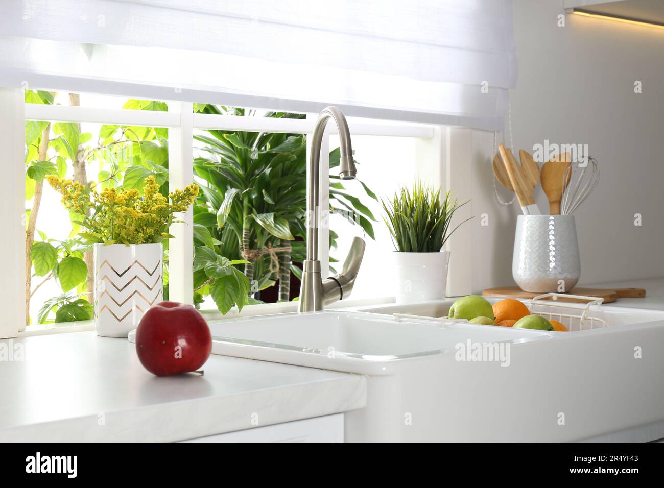 Beautiful white sink near window in modern kitchen Stock Photo - Alamy