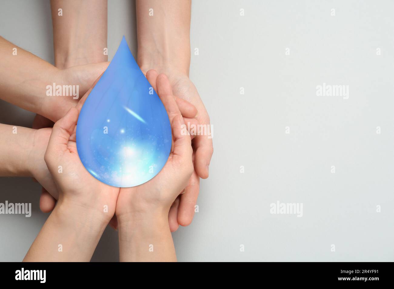 People holding paper water drop on light grey background, top view ...