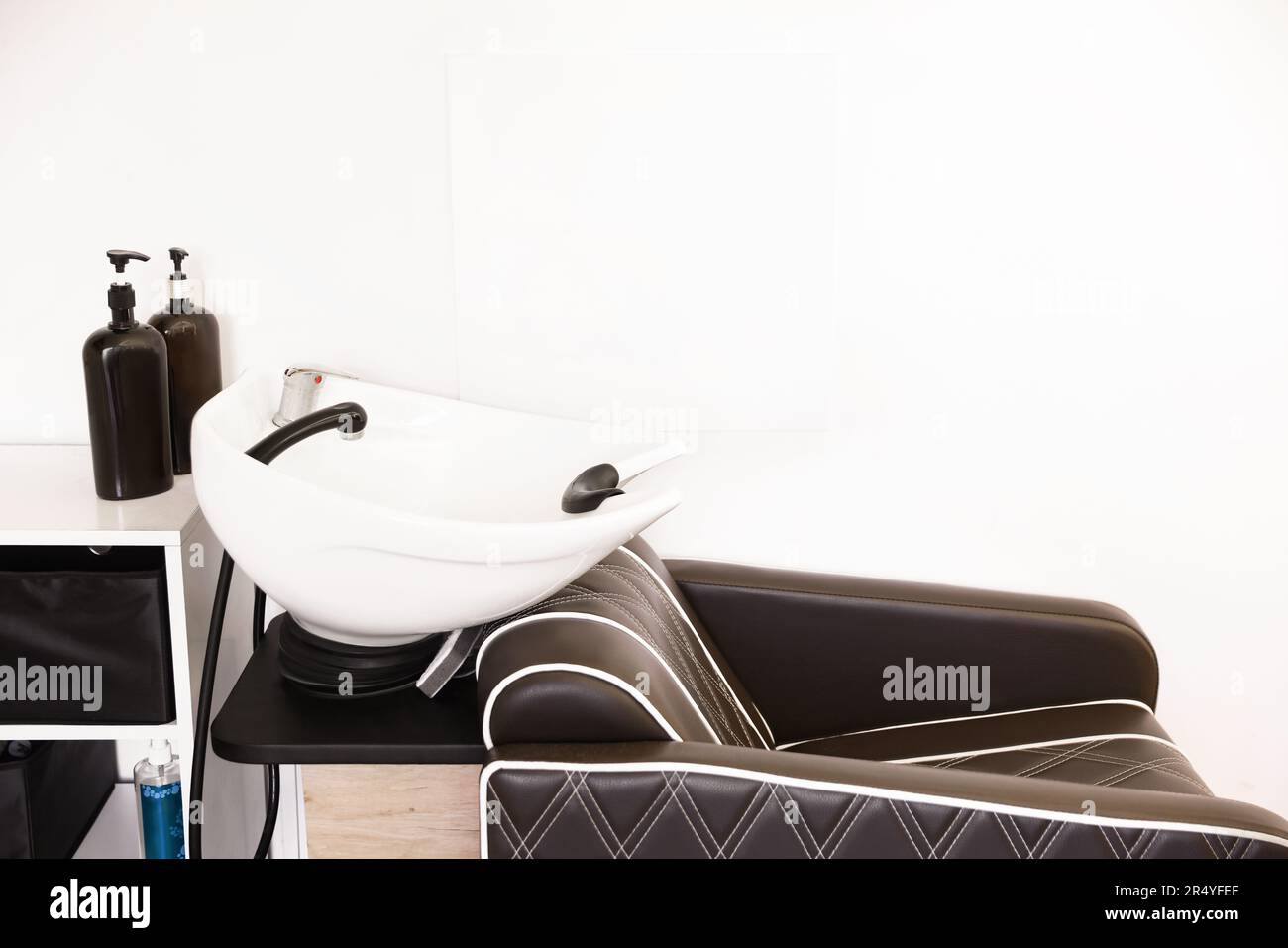 Modern wash unit with professional care products in barbershop Stock ...