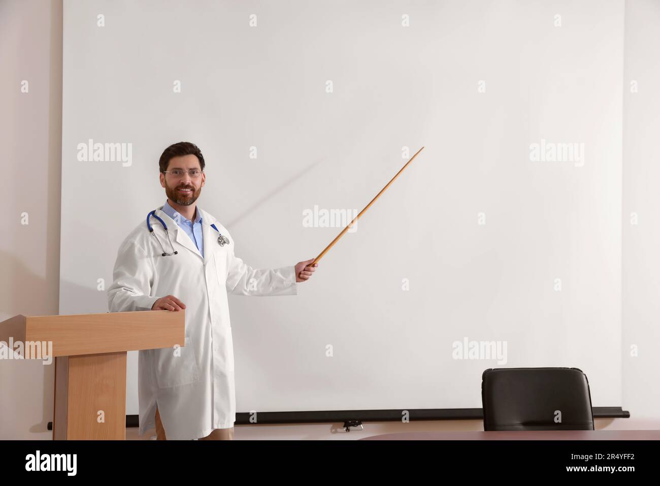 Doctor giving lecture in conference room with projection screen Stock ...