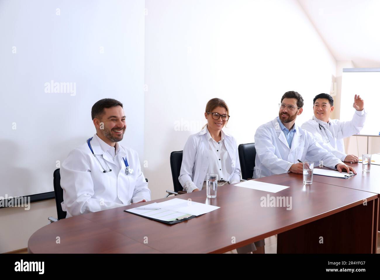 Team happy doctors sitting hi-res stock photography and images - Alamy