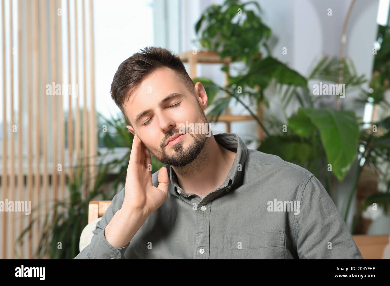 Young man suffering ear pain hi-res stock photography and images - Alamy