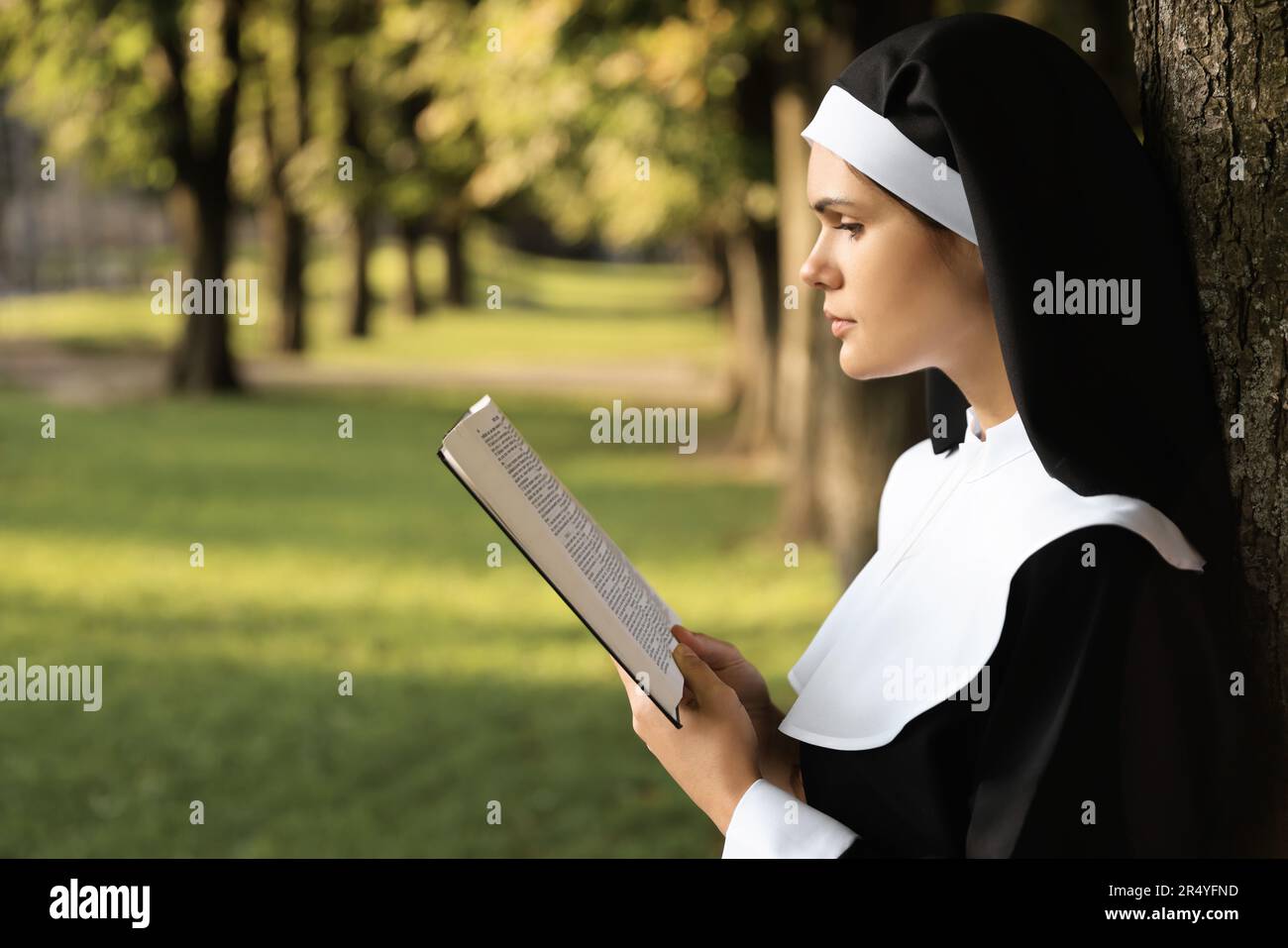 Young nun reading bible hi-res stock photography and images - Alamy