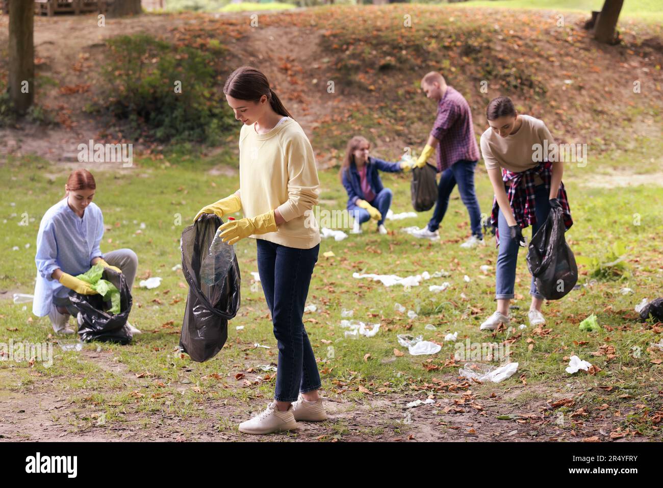 Group of people with plastic bags collecting garbage in park Stock ...