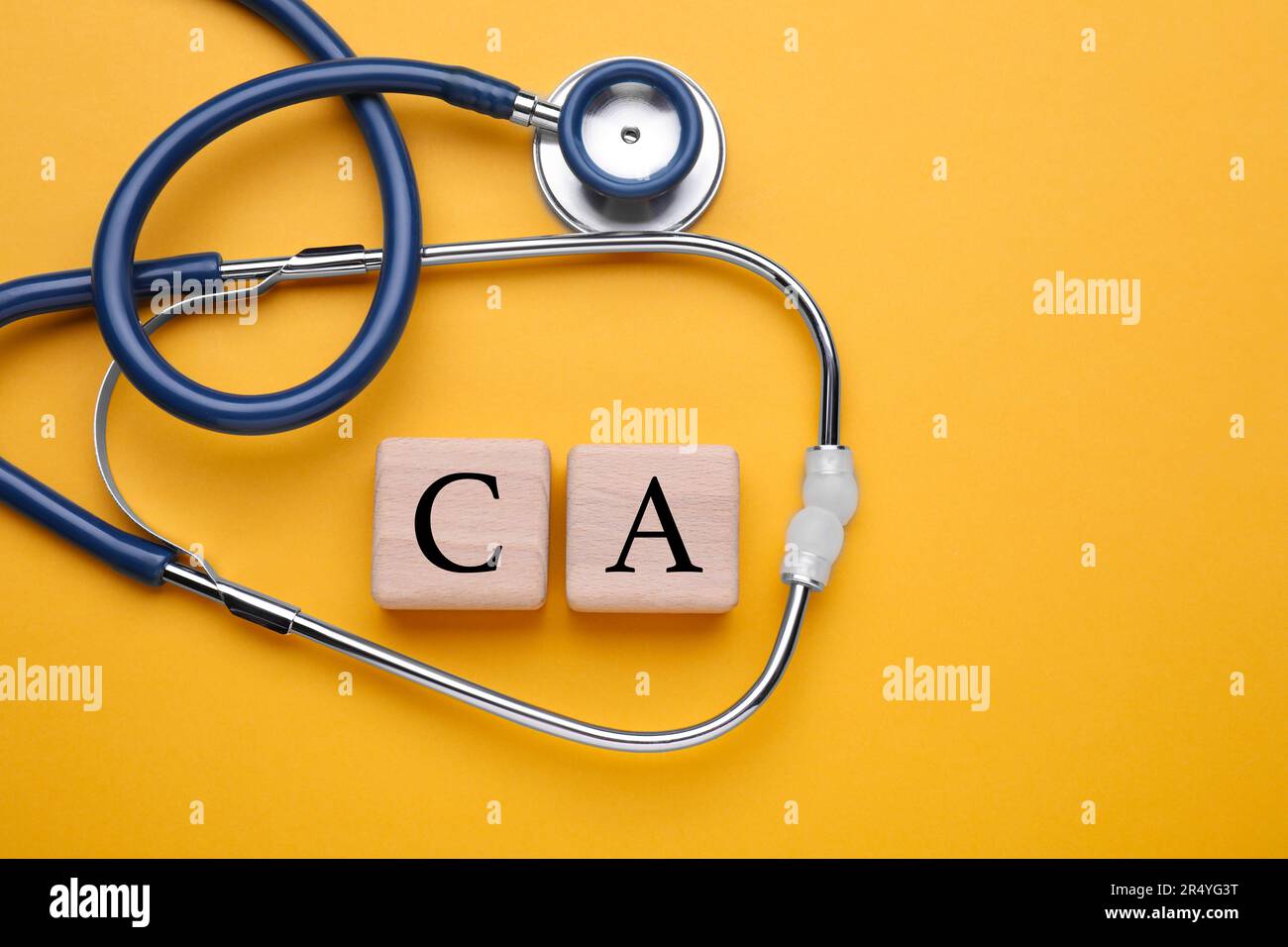 Stethoscope and calcium symbol made of wooden cubes with letters on ...