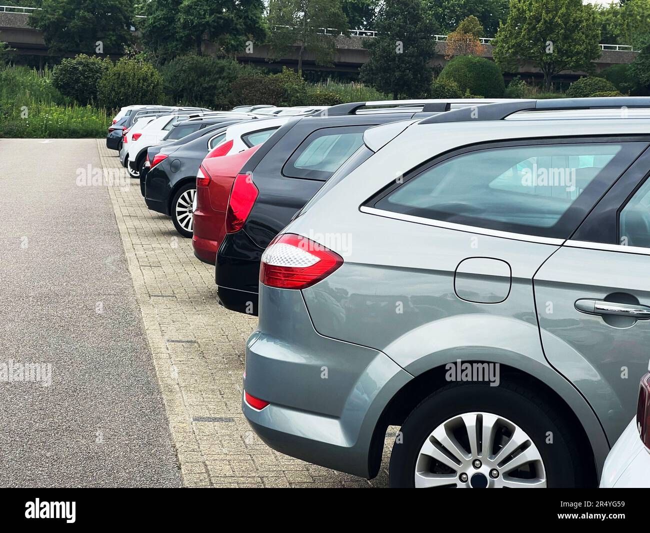 View of many different cars parked near road Stock Photo - Alamy
