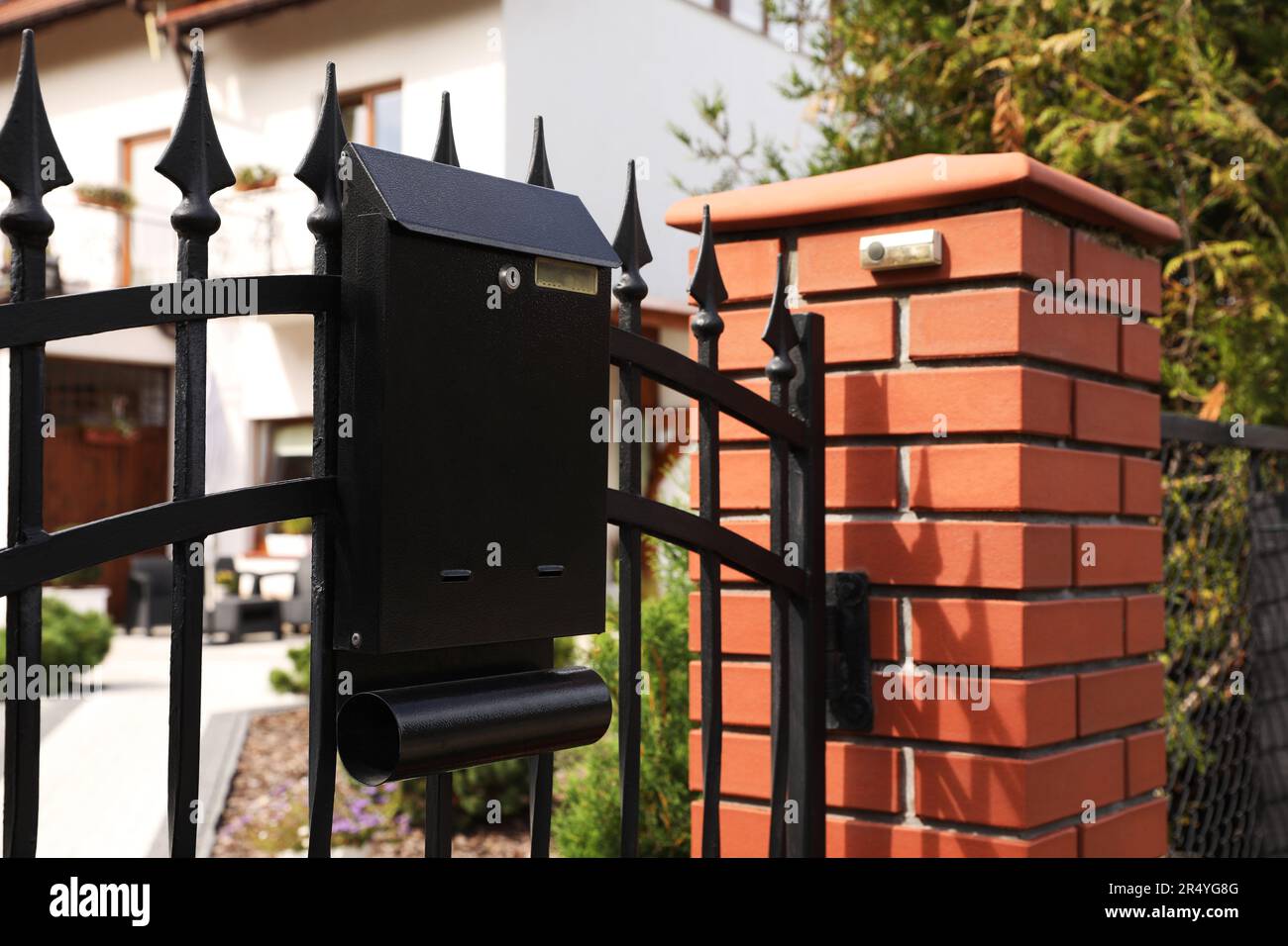 Black metal letter box on fence outdoors Stock Photo - Alamy