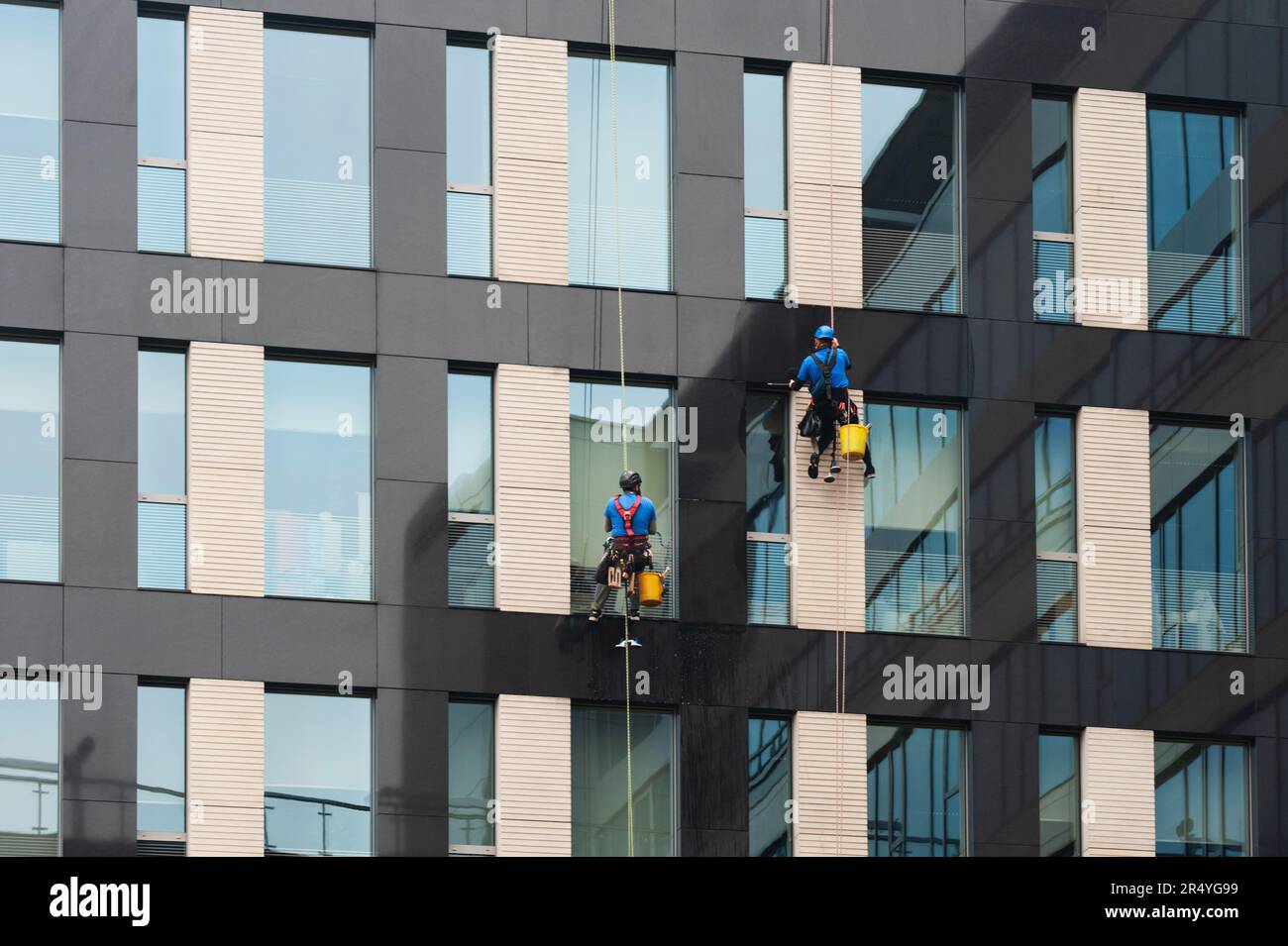 Men washing windows on modern building outdoors Stock Photo - Alamy