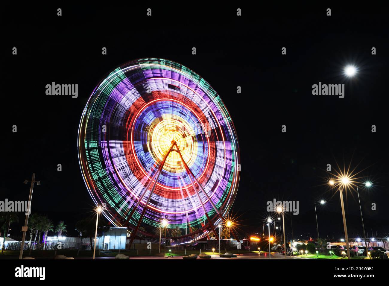 Beautiful glowing Ferris wheel against dark sky Stock Photo - Alamy