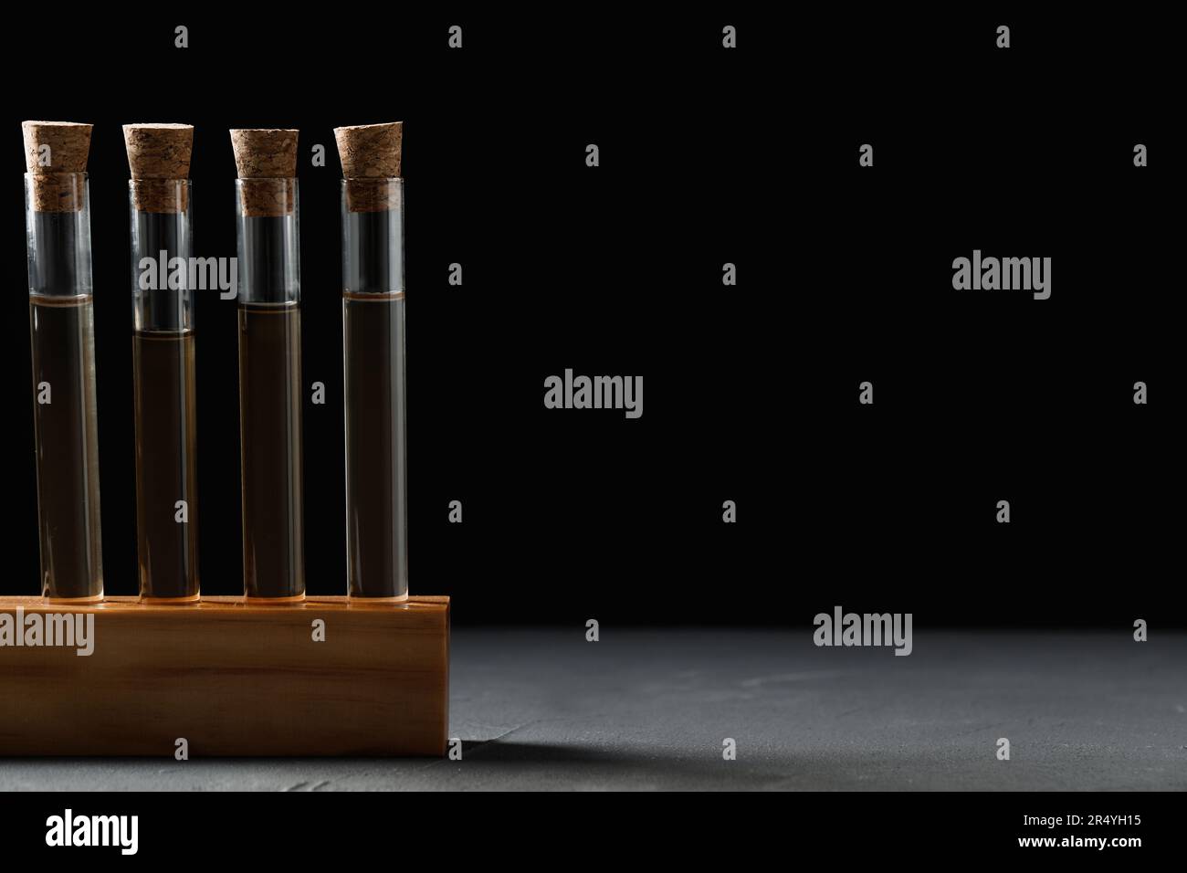 Test tubes with liquid in stand on grey table. Space for text Stock ...
