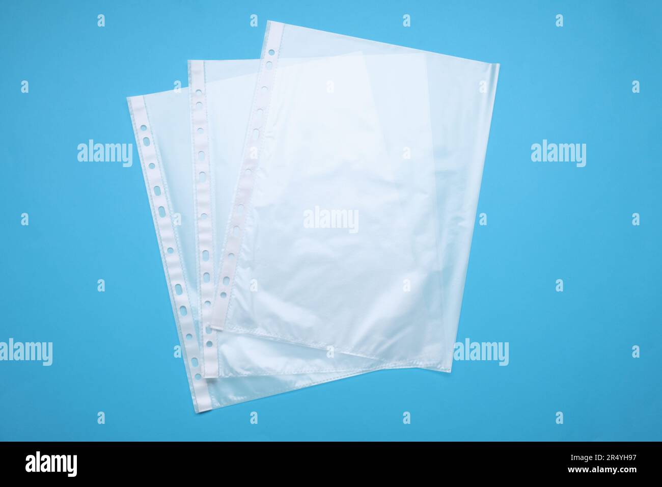 Punched pockets on light blue background, flat lay Stock Photo - Alamy