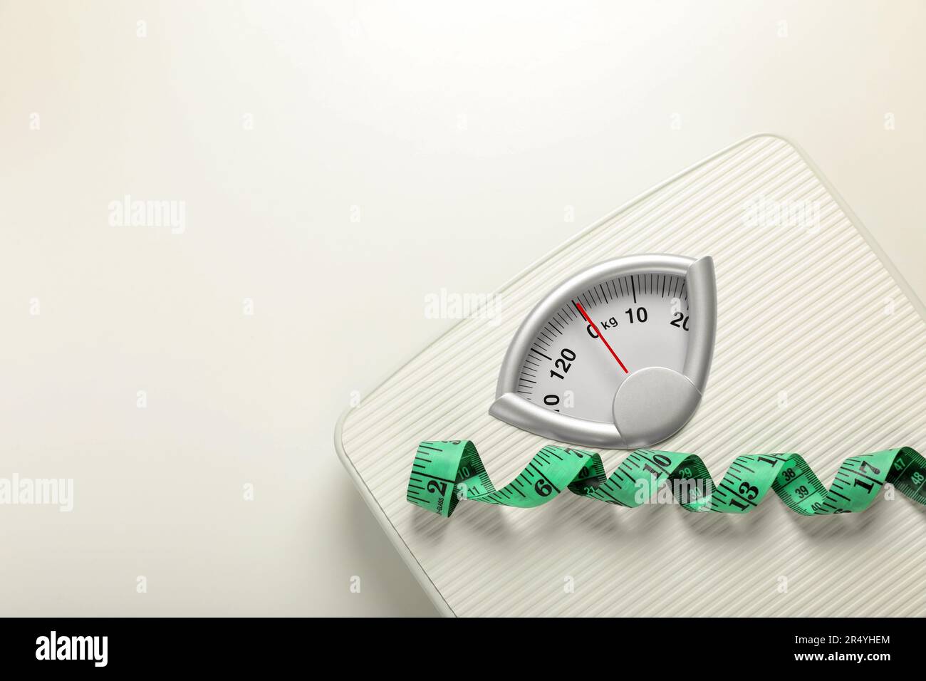 Scales and measuring tape on white background, top view. Space for text ...