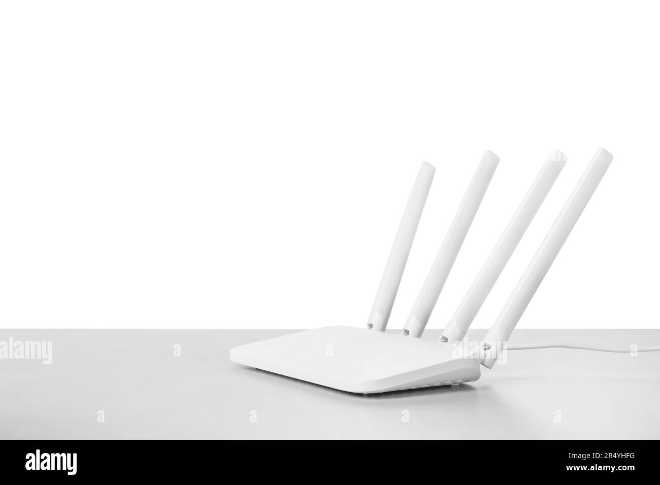 New modern Wi-Fi router on light grey table against white background ...