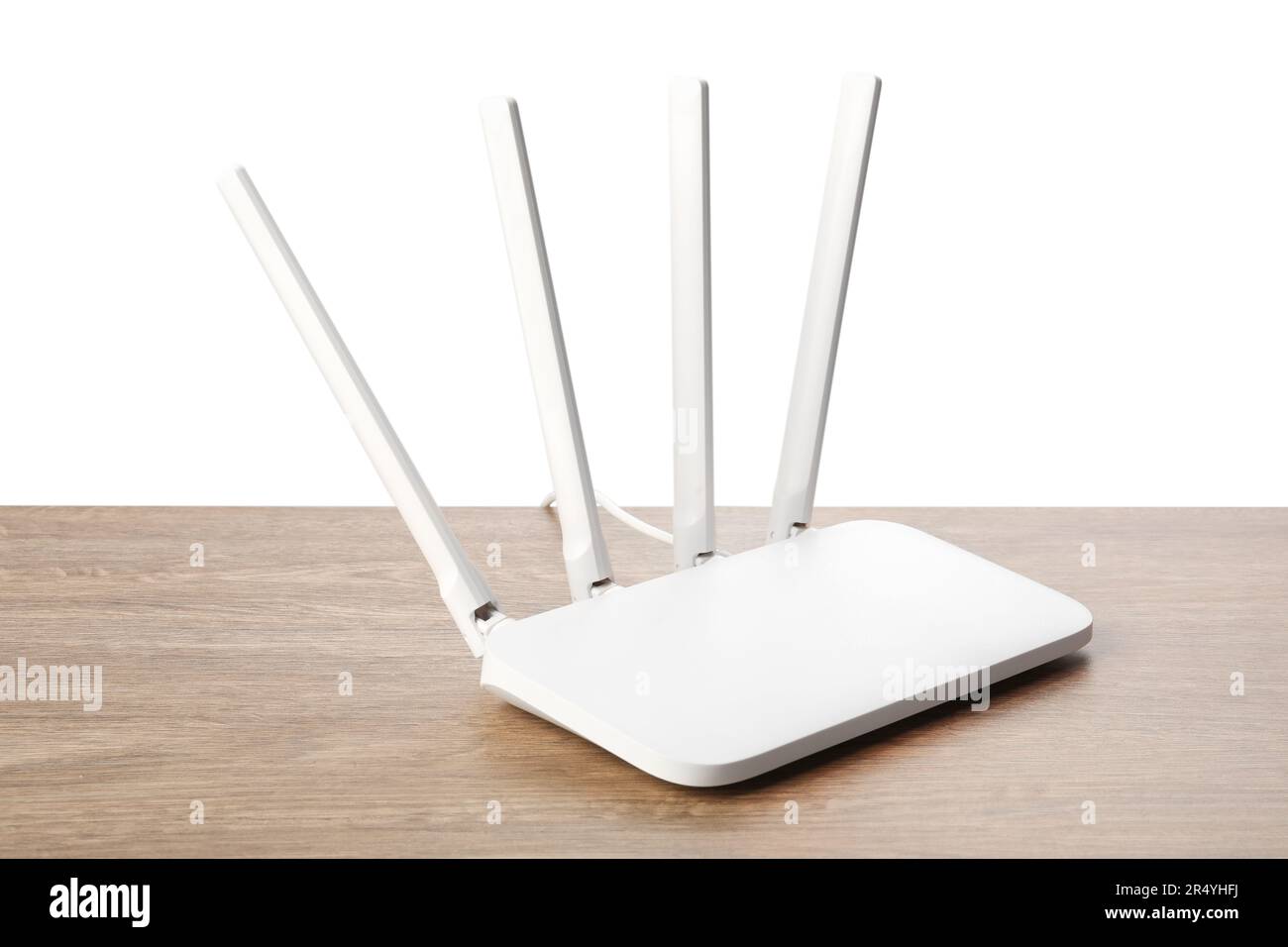 New modern Wi-Fi router on wooden table against white background Stock ...