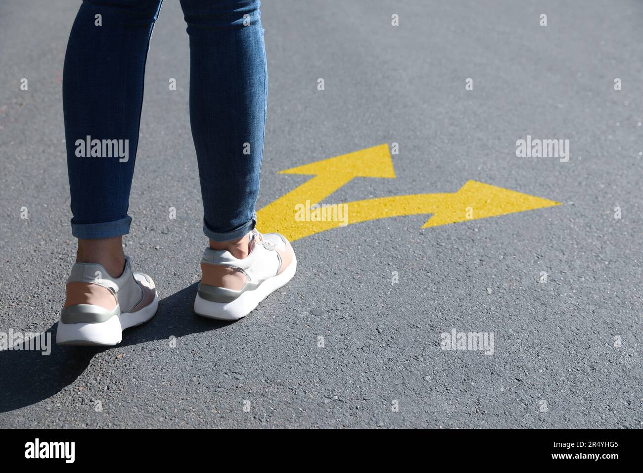 Choice of way. Woman walking towards drawn mark on road, closeup ...