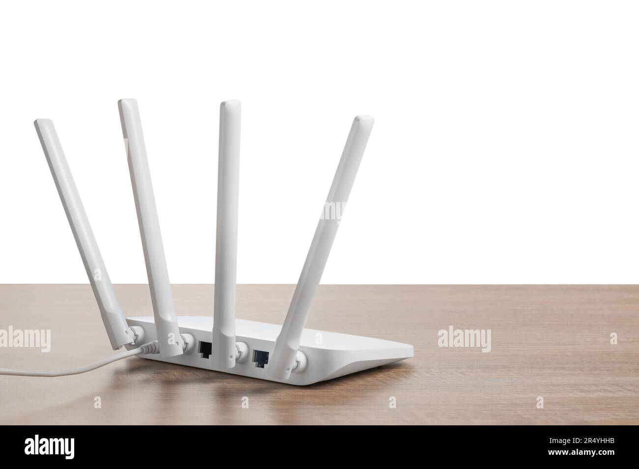 New modern Wi-Fi router on wooden table against white background. Space ...