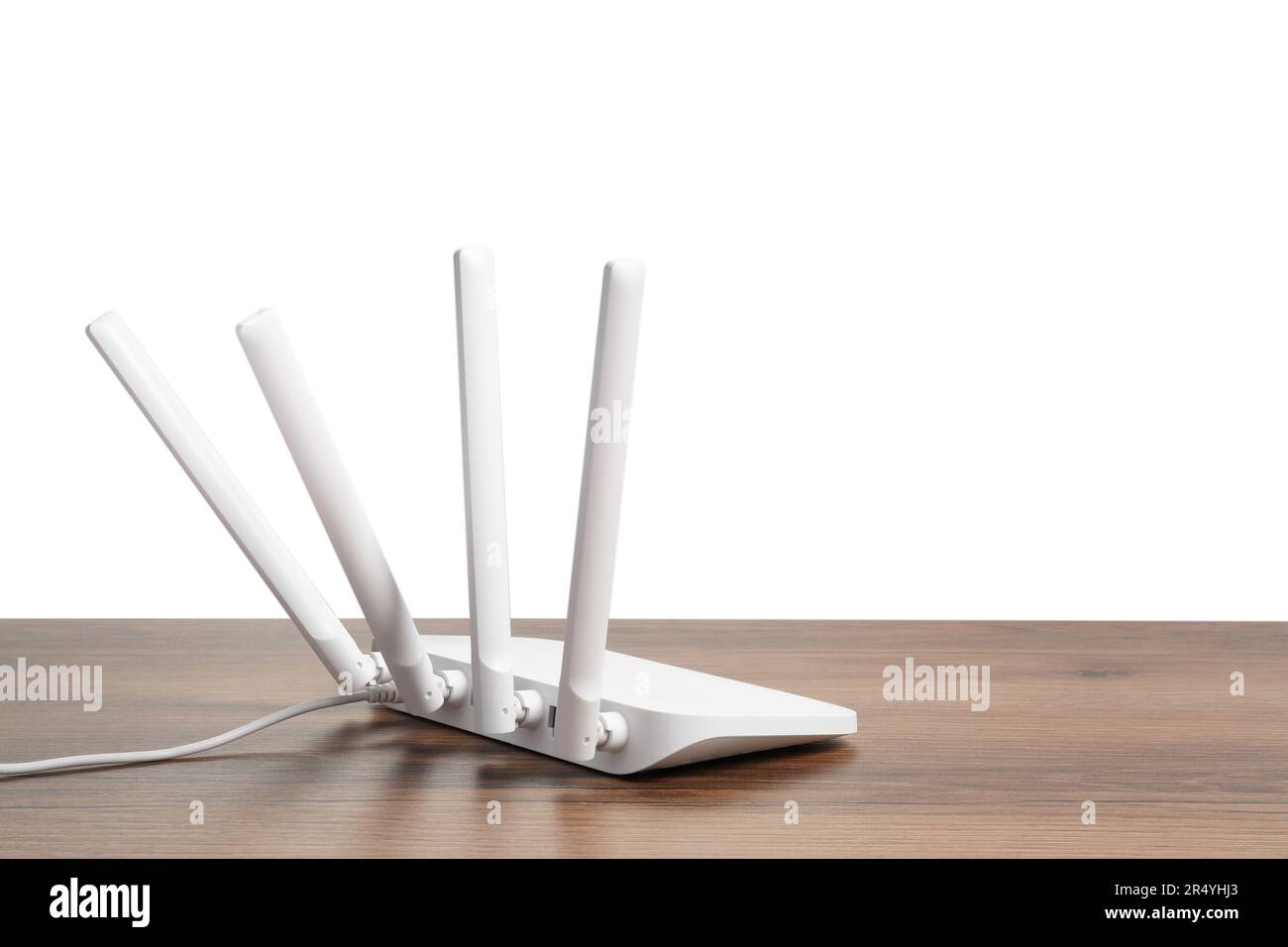 New modern Wi-Fi router on wooden table against white background. Space ...